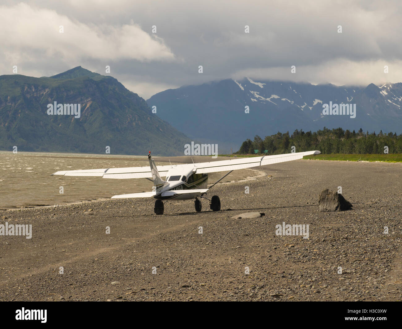 A bush plane takes off from the shore of Chinitna Bay, Lake Clark ...