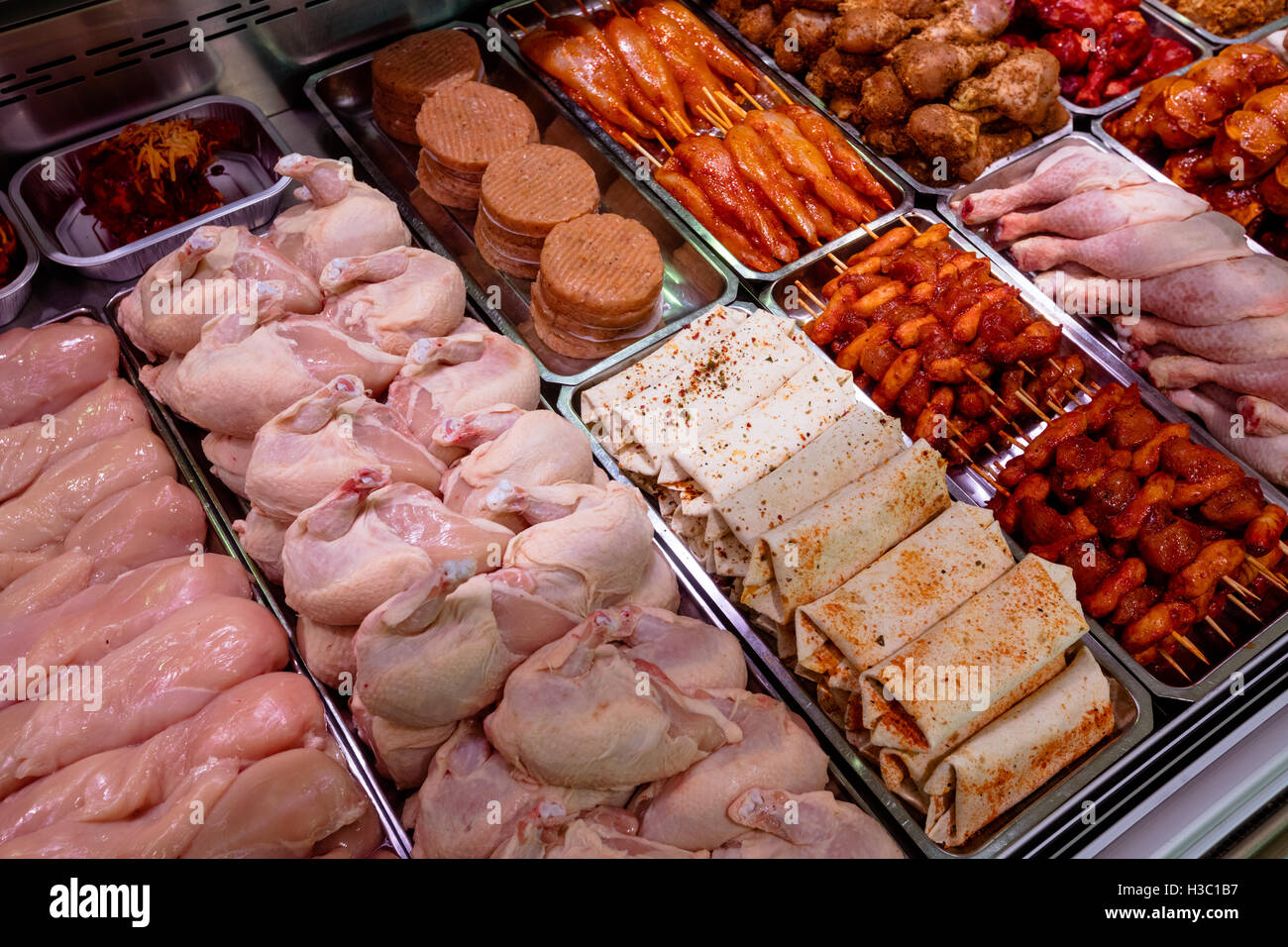 Variety of marinated meat at display counter Stock Photo - Alamy