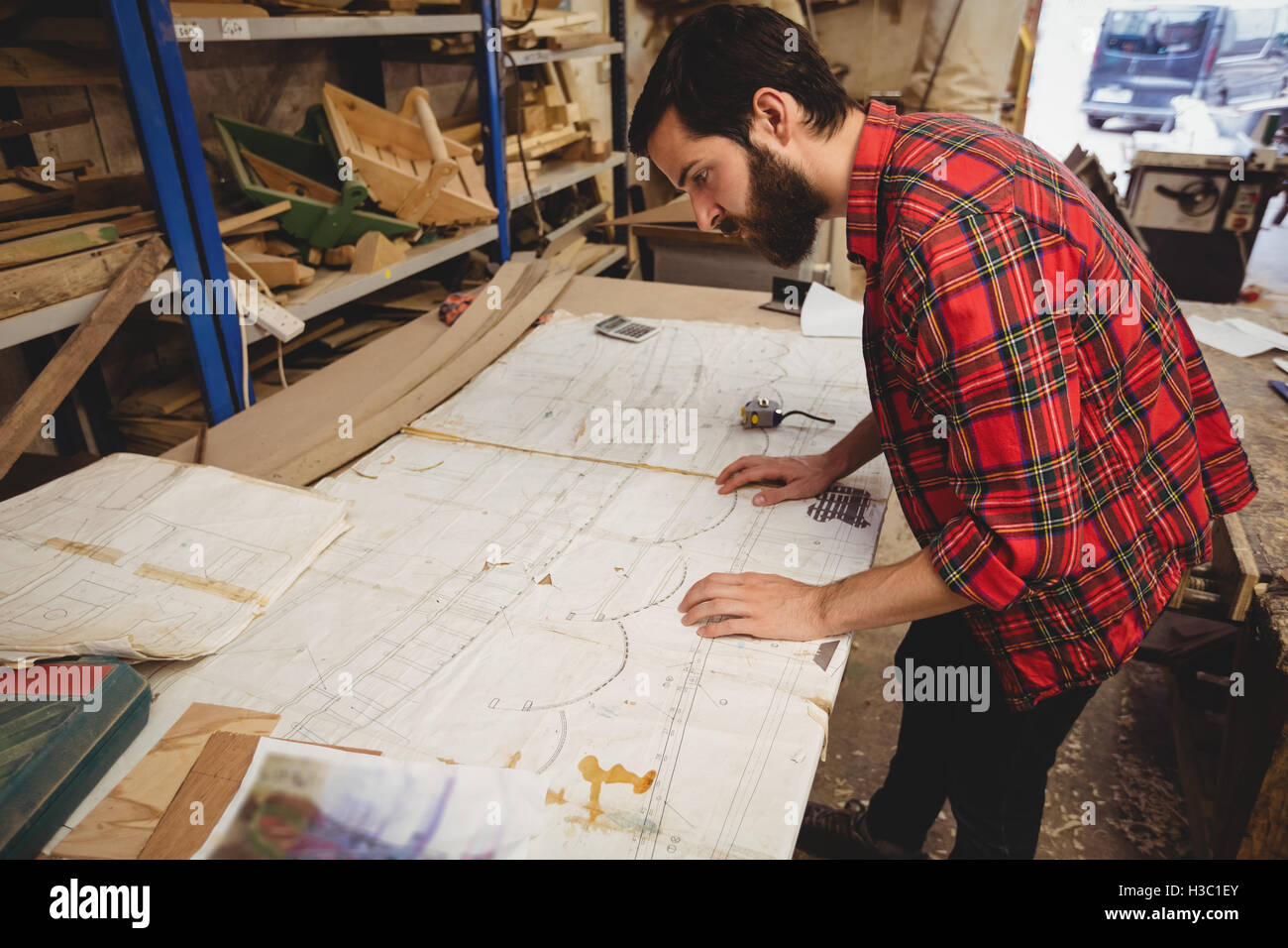 Man looking at blueprint Stock Photo - Alamy