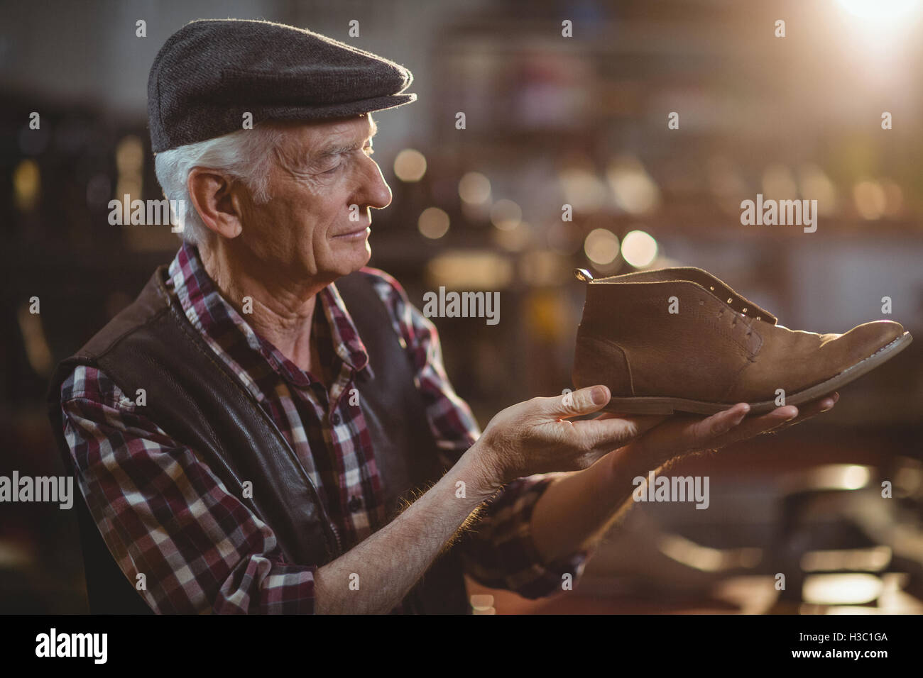 Shoemaker examining a shoe Stock Photo - Alamy