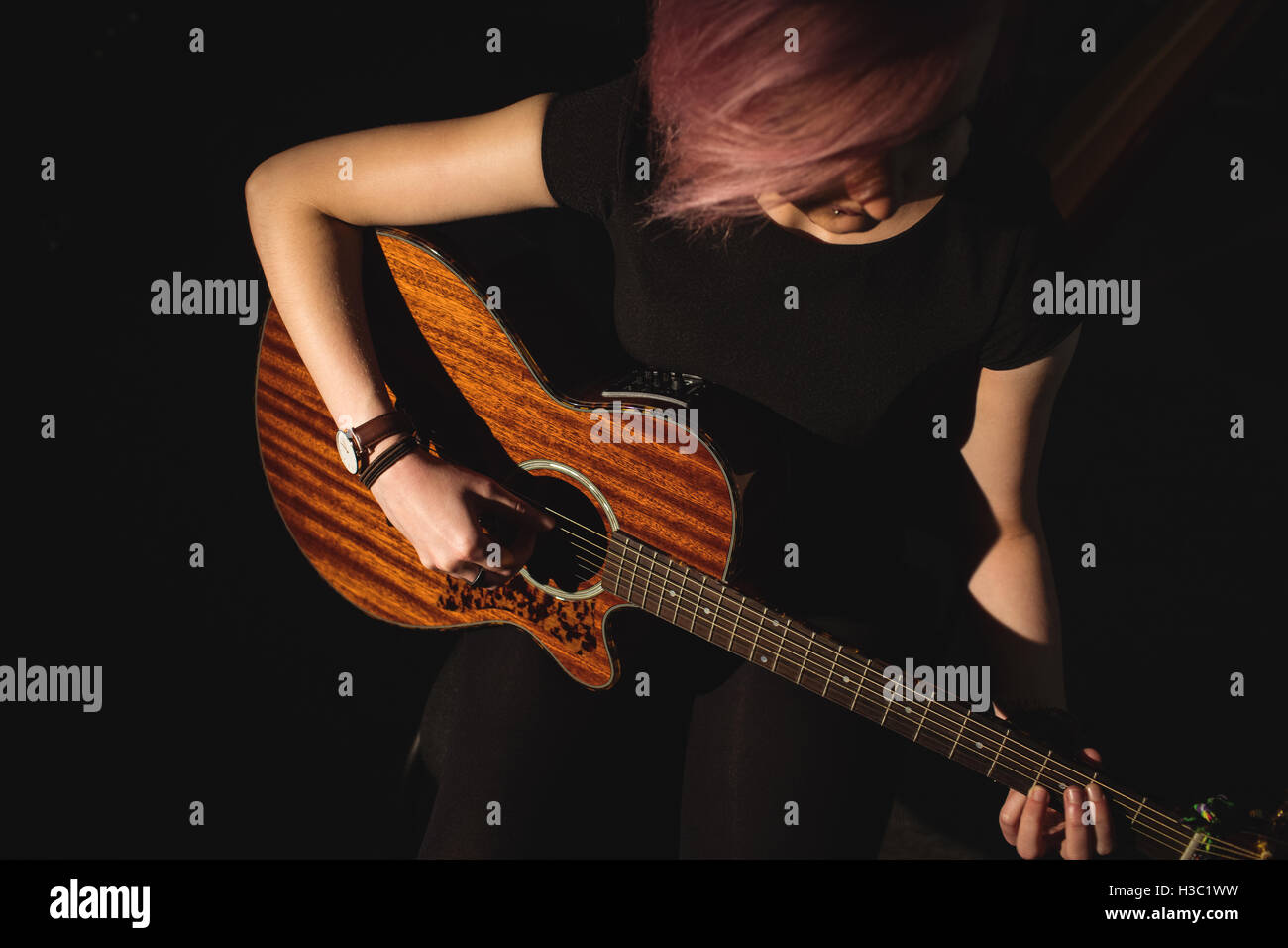 Woman playing a guitar Stock Photo - Alamy