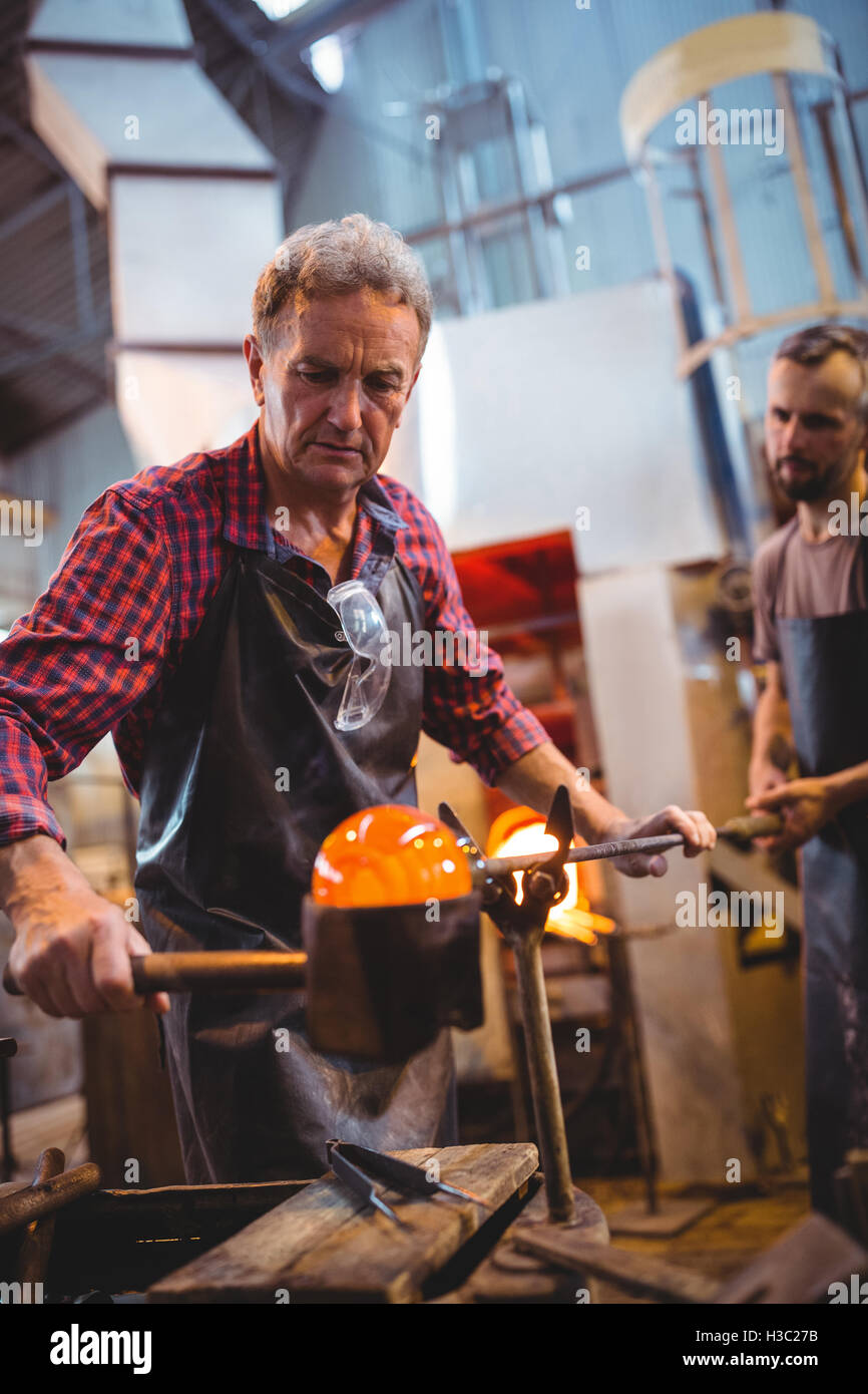 Glassblower forming and shaping a molten glass Stock Photo - Alamy