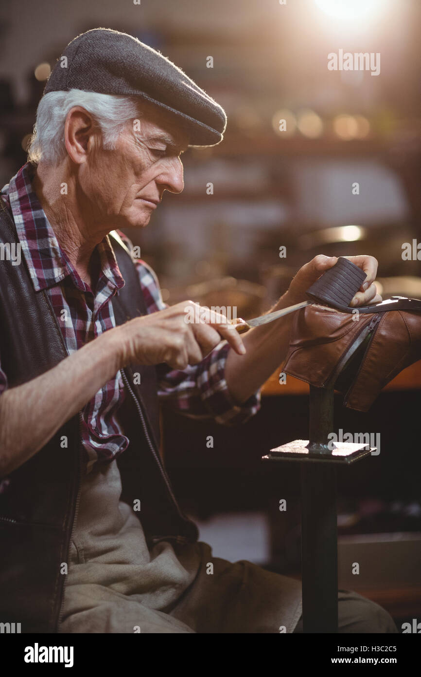 Shoemaker repairing a shoe Stock Photo - Alamy