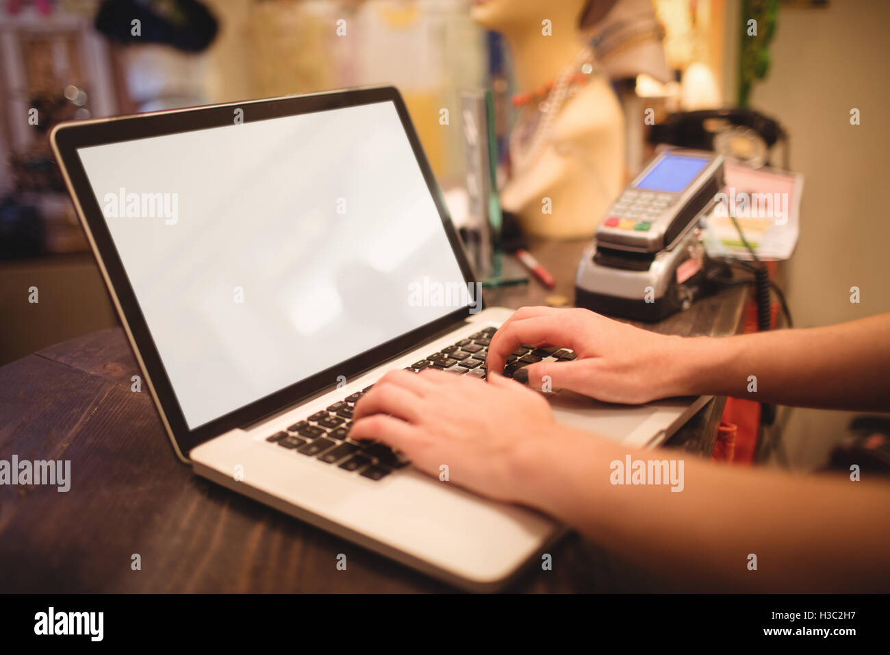 Shop staff using mobile payment hi-res stock photography and images - Alamy
