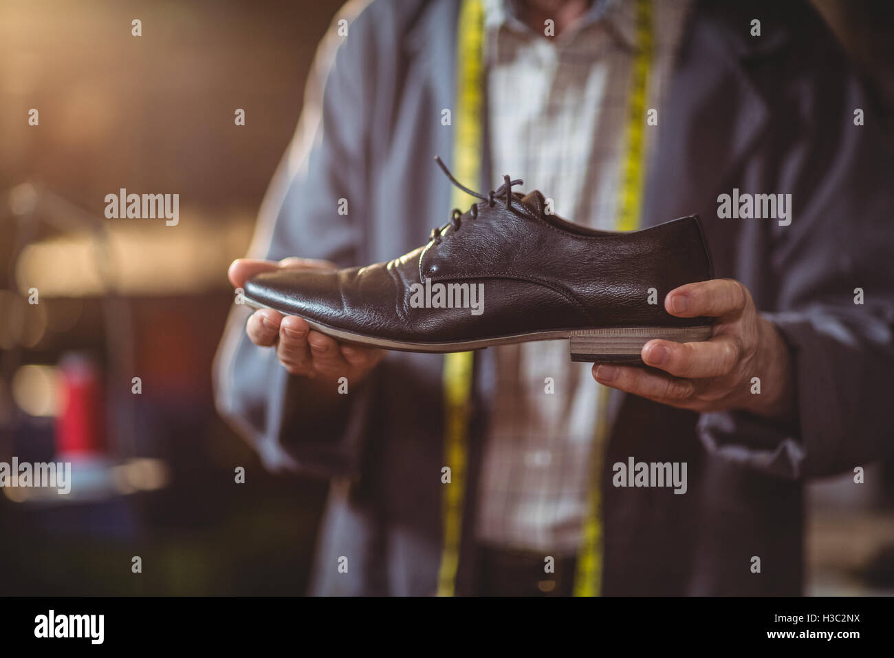 Shoemaker examining a shoe Stock Photo - Alamy