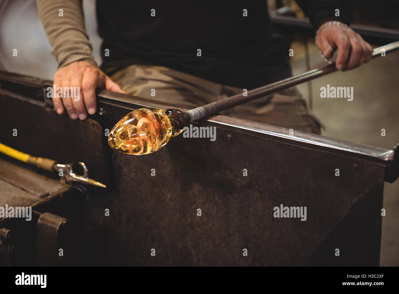 Glassblower shaping a molten glass Stock Photo - Alamy