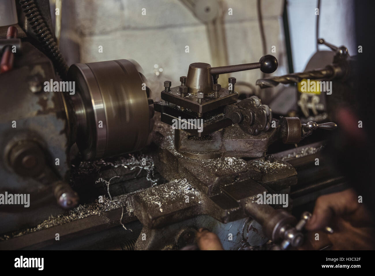 Mechanic working on a lathe machine Stock Photo - Alamy