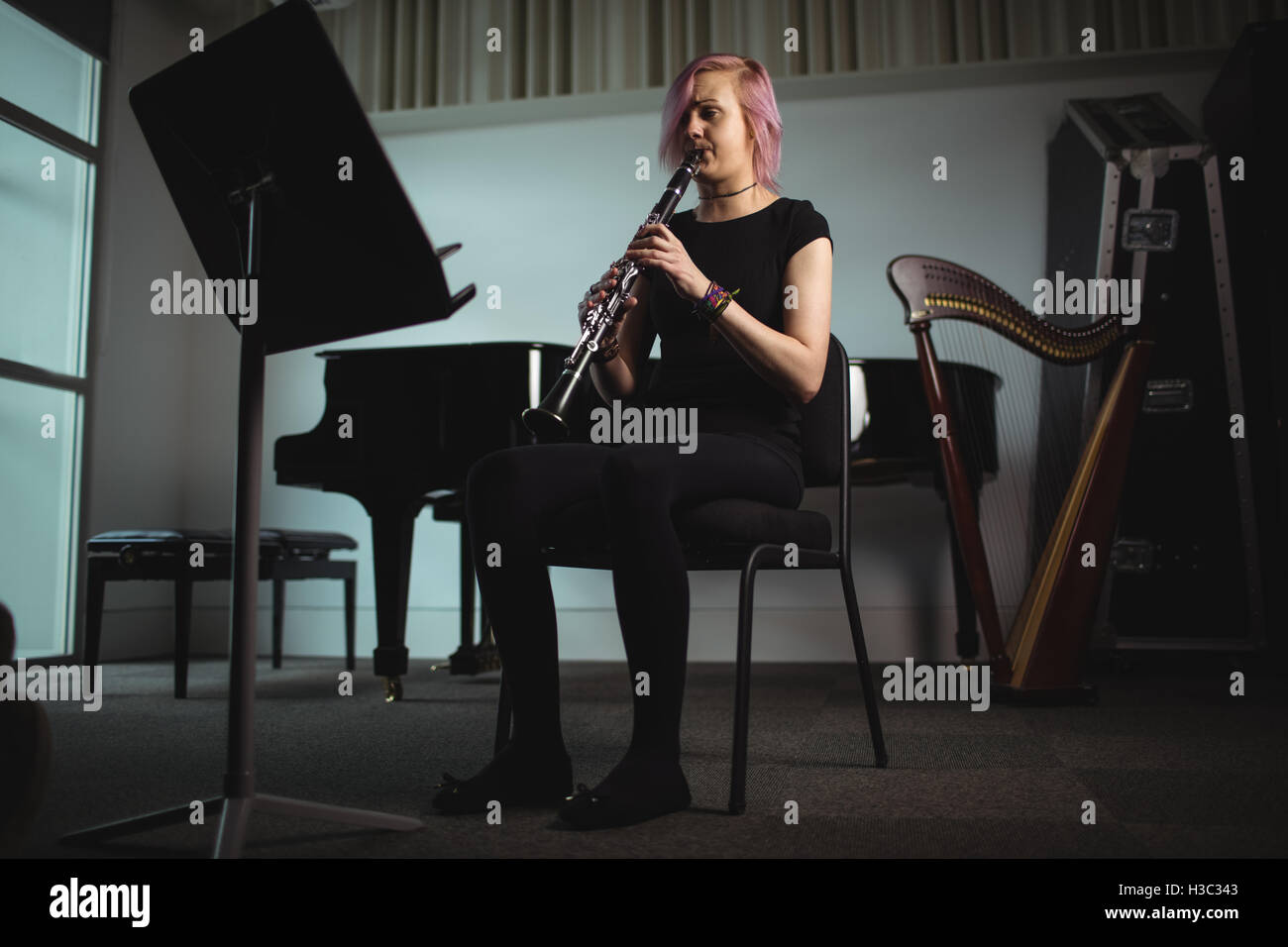 Woman playing a clarinet in music school Stock Photo - Alamy