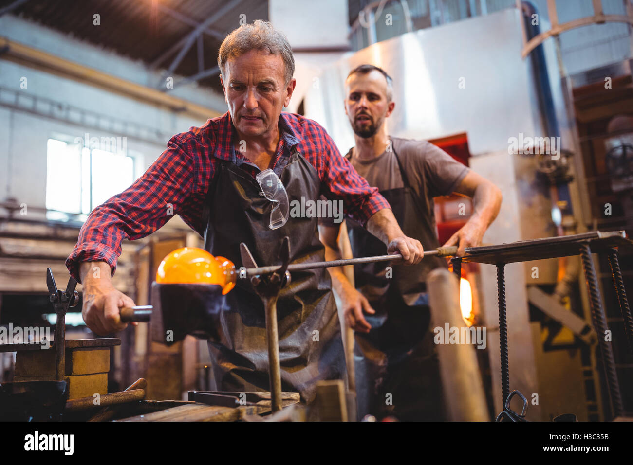 Glassblower forming and shaping a molten glass Stock Photo - Alamy