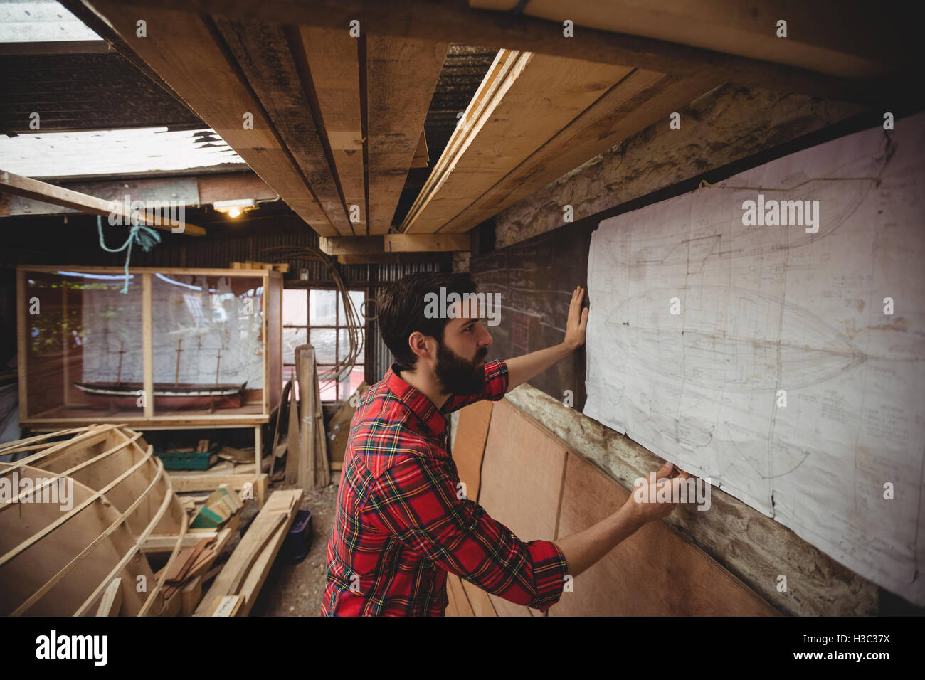 Man looking at blueprint Stock Photo - Alamy