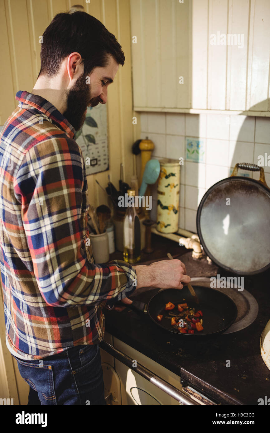 Man preparing food in kitchen Stock Photo - Alamy