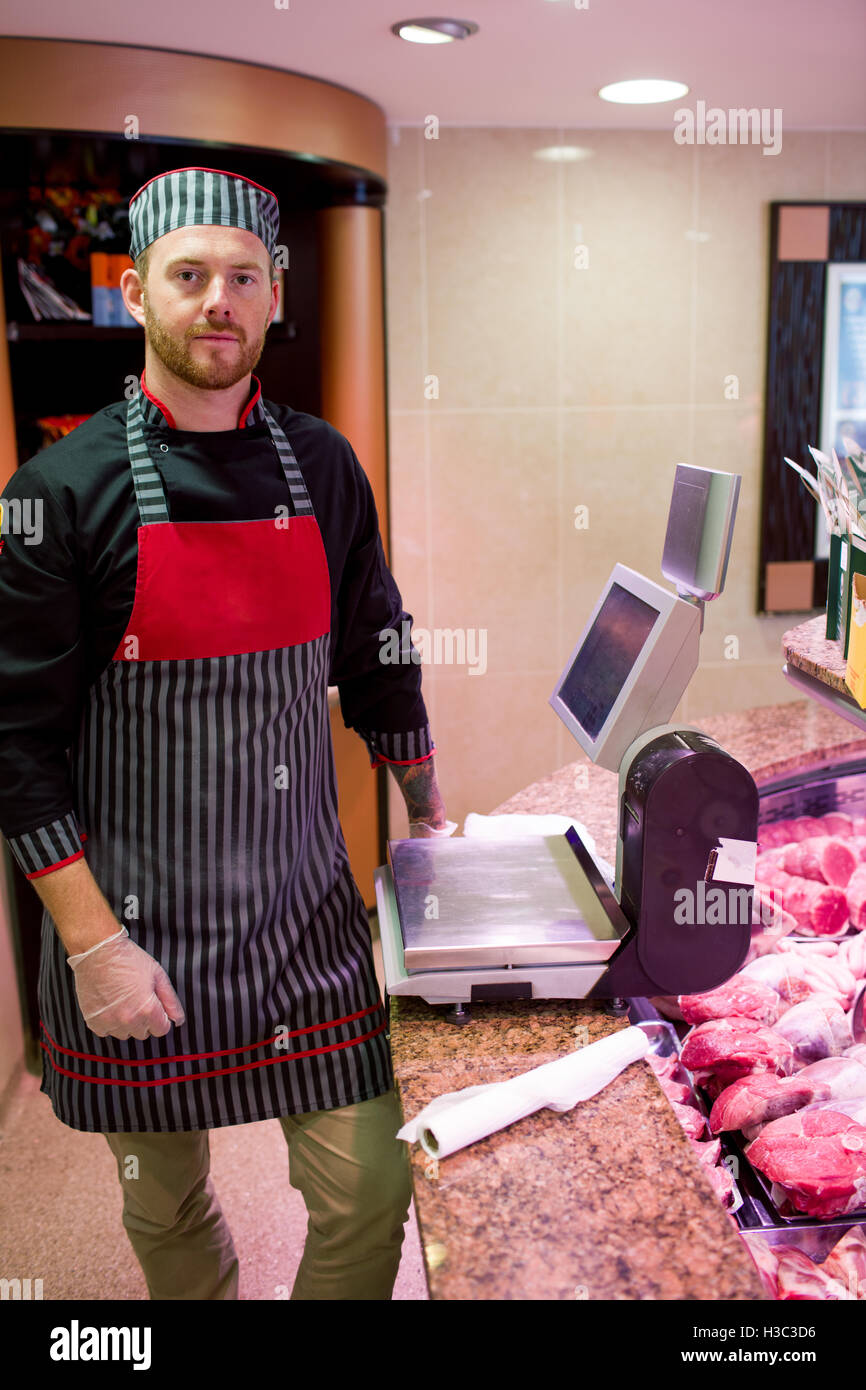 Portrait of butcher standing at counter Stock Photo - Alamy