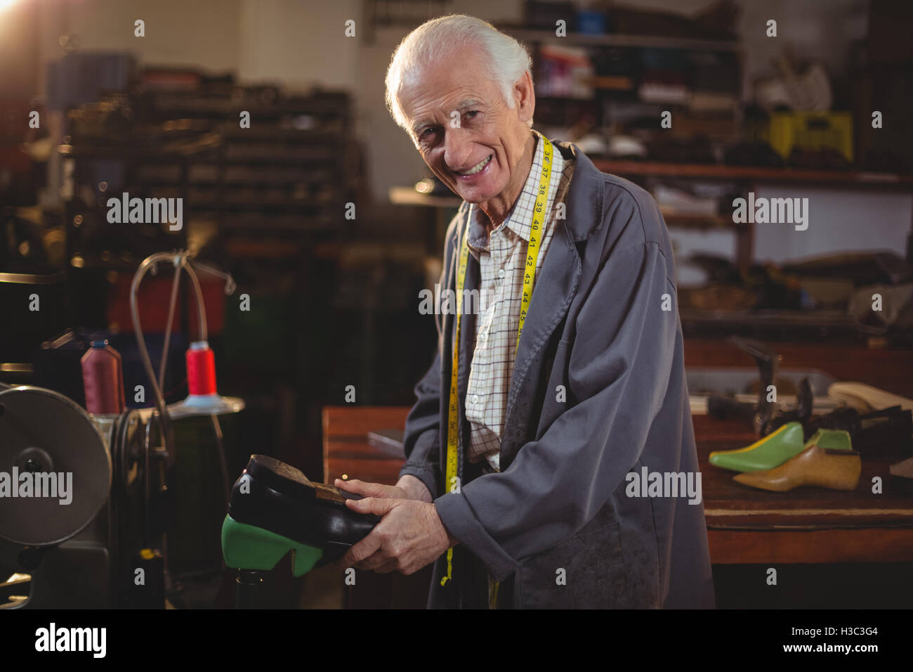 Portrait of smiling shoemaker repairing a shoe Stock Photo - Alamy