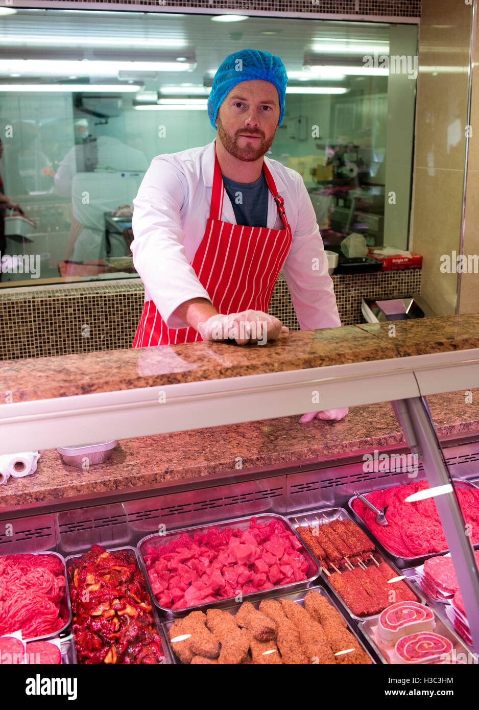 Portrait of butcher standing at meat counter Stock Photo - Alamy
