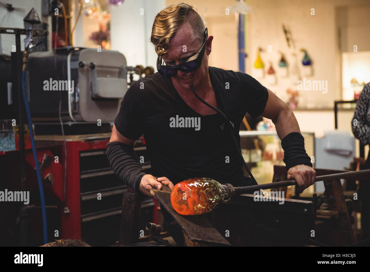 Glassblower shaping a molten glass Stock Photo - Alamy
