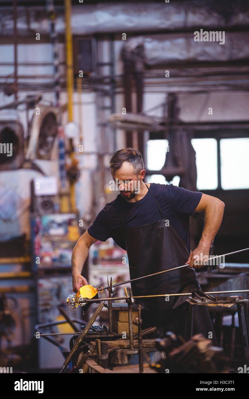 Glassblower forming and shaping a molten glass Stock Photo - Alamy