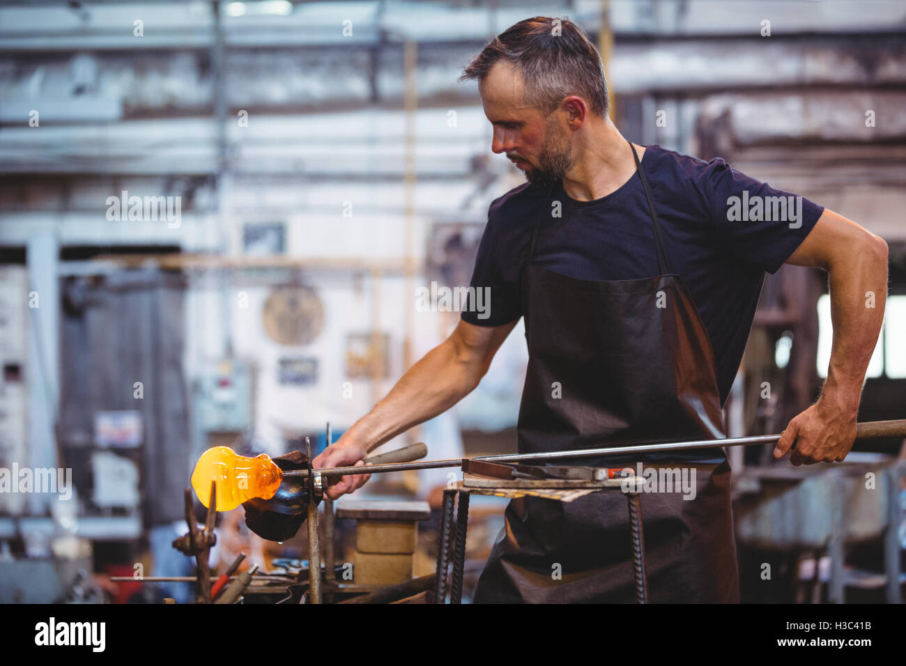 Glassblower forming and shaping a molten glass Stock Photo - Alamy