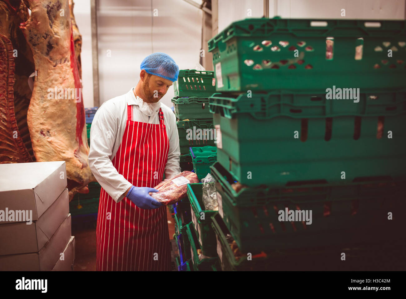 Butcher arranging meat in crates Stock Photo - Alamy