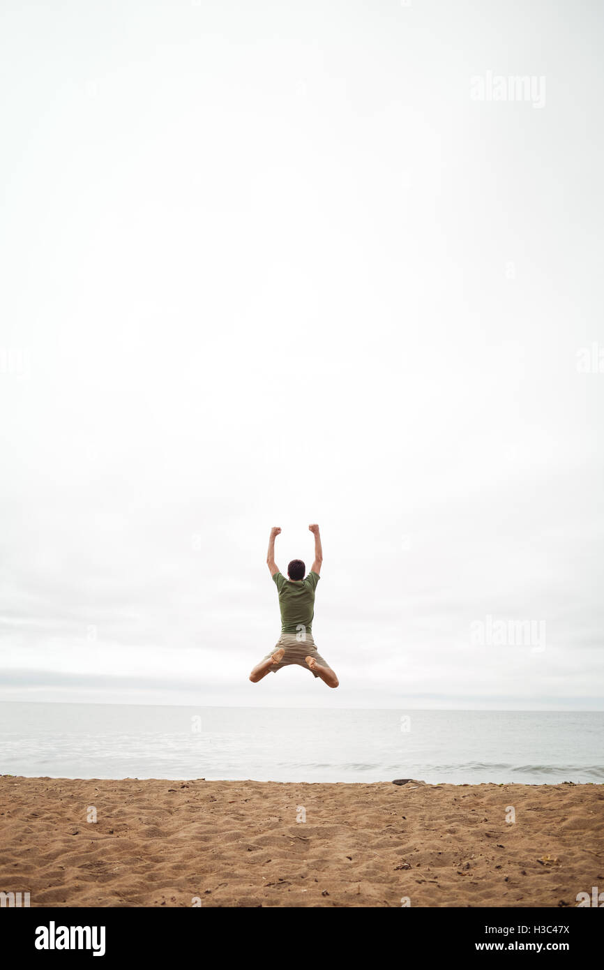Man jumping on beach hi-res stock photography and images - Alamy
