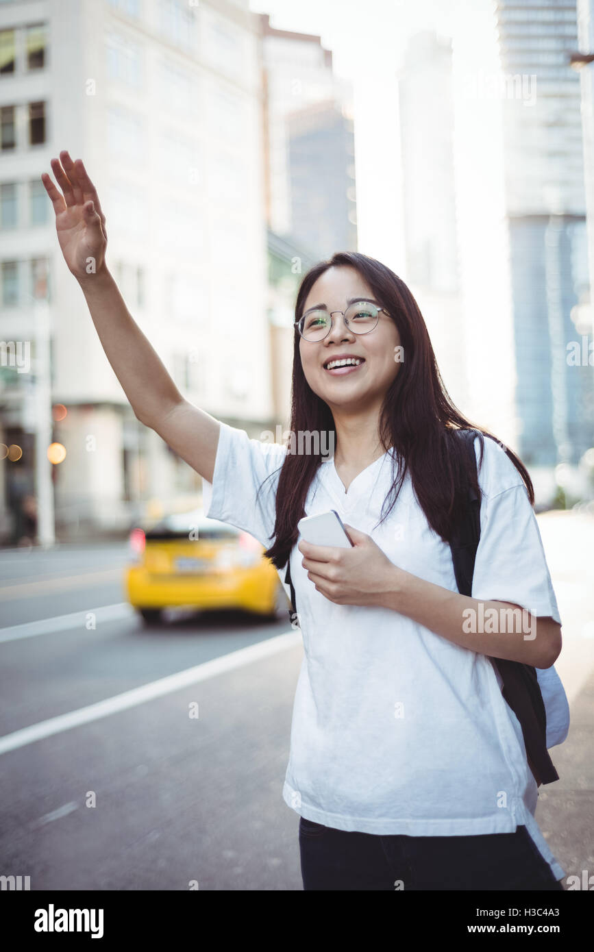 Woman calling taxi hi-res stock photography and images - Alamy