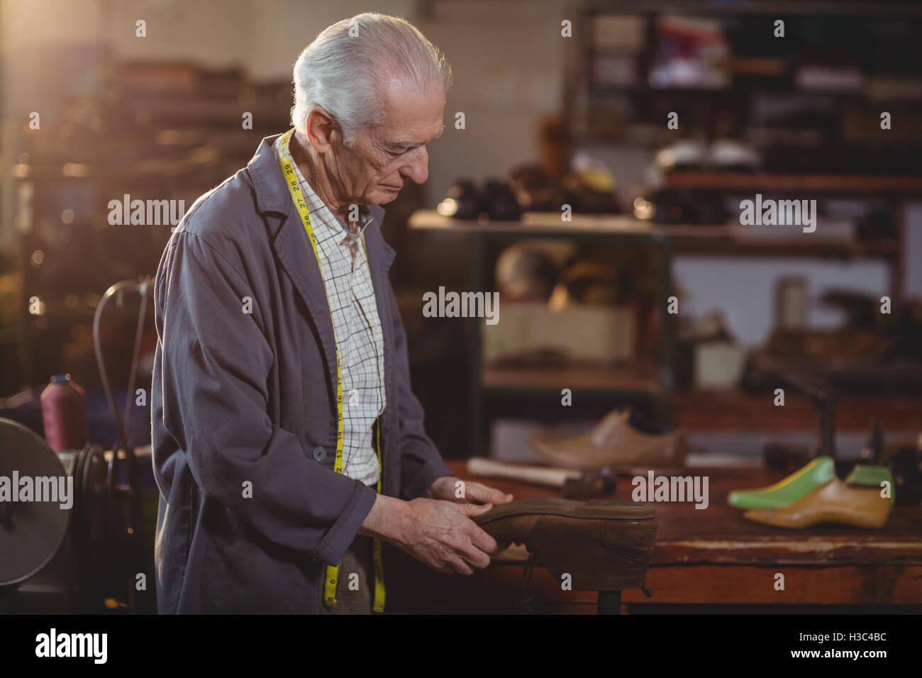 Shoemaker repairing a shoe Stock Photo - Alamy
