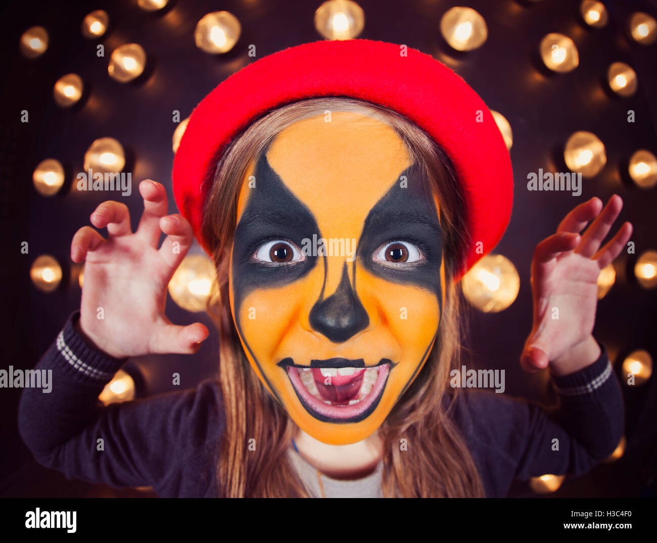 Pretty girl with face painting of a pumpkin. Halloween theme Stock ...
