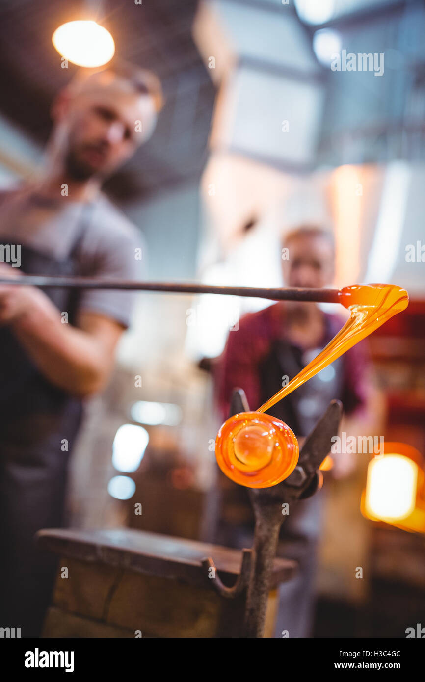 Glassblower shaping a molten glass Stock Photo - Alamy