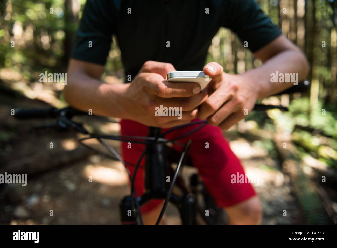 Cyclist using mobile phone hi-res stock photography and images - Alamy