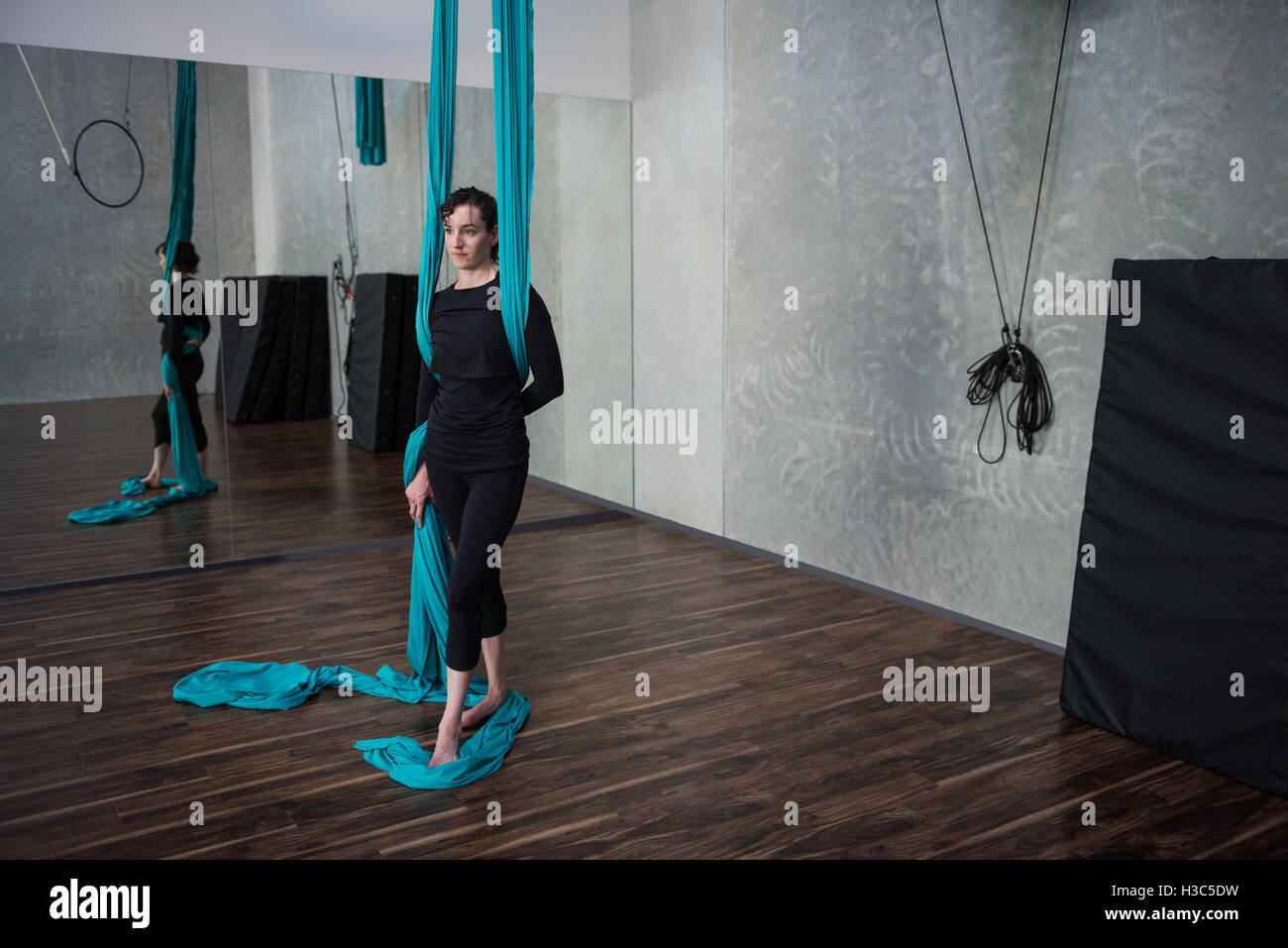 Gymnast holding fabric rope Stock Photo - Alamy