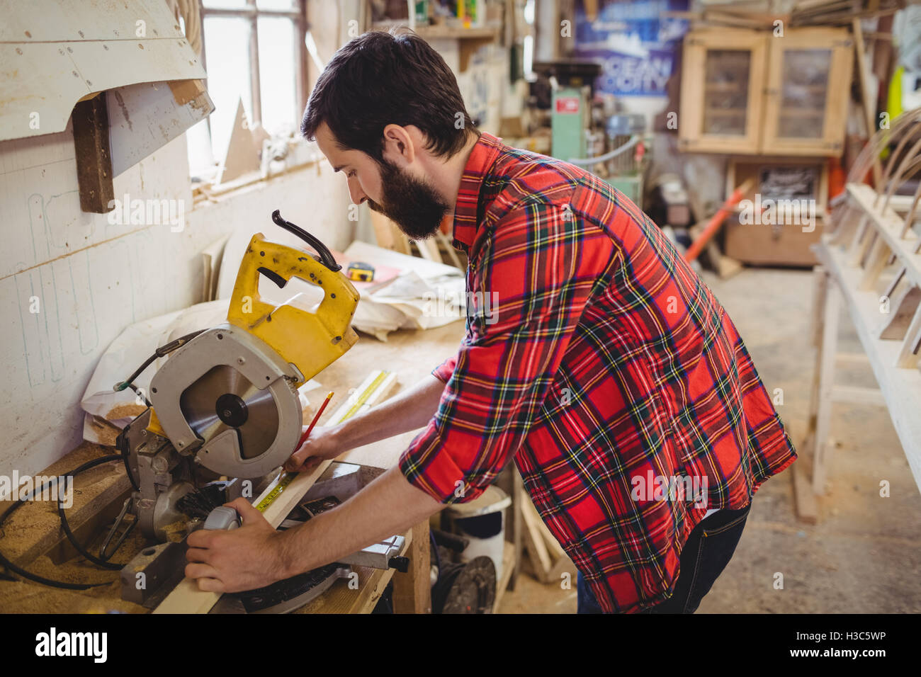 Man marking on wooden plank Stock Photo - Alamy