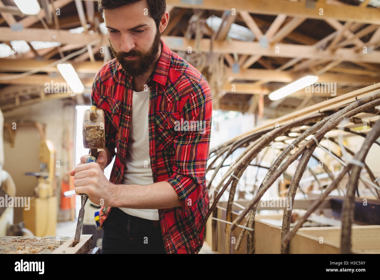 Man working over a wooden plank Stock Photo - Alamy