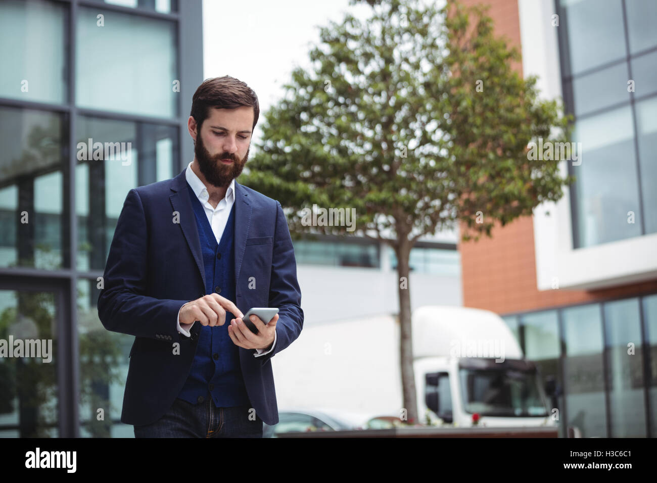 Businessman using mobile phone Stock Photo - Alamy