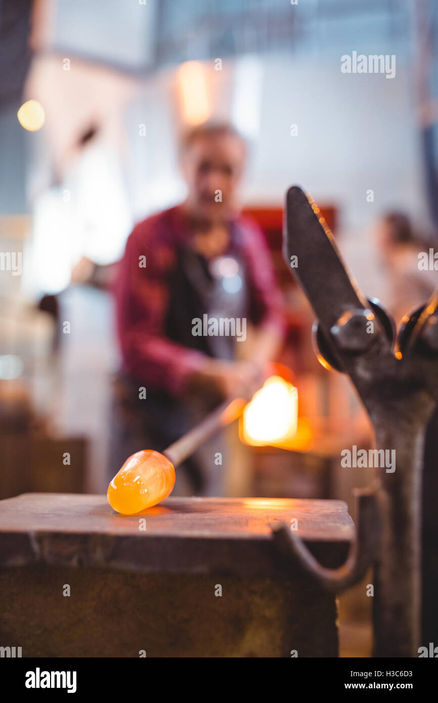 Glassblower shaping a molten glass Stock Photo - Alamy
