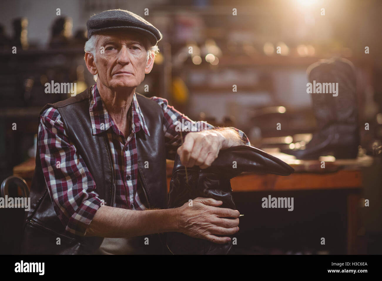 Portrait of shoemaker holding a shoemaker stand Stock Photo - Alamy