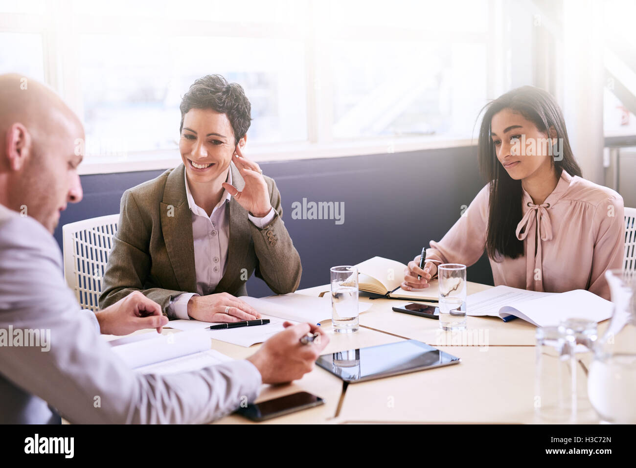 Business meeting between three professional partners early in the ...