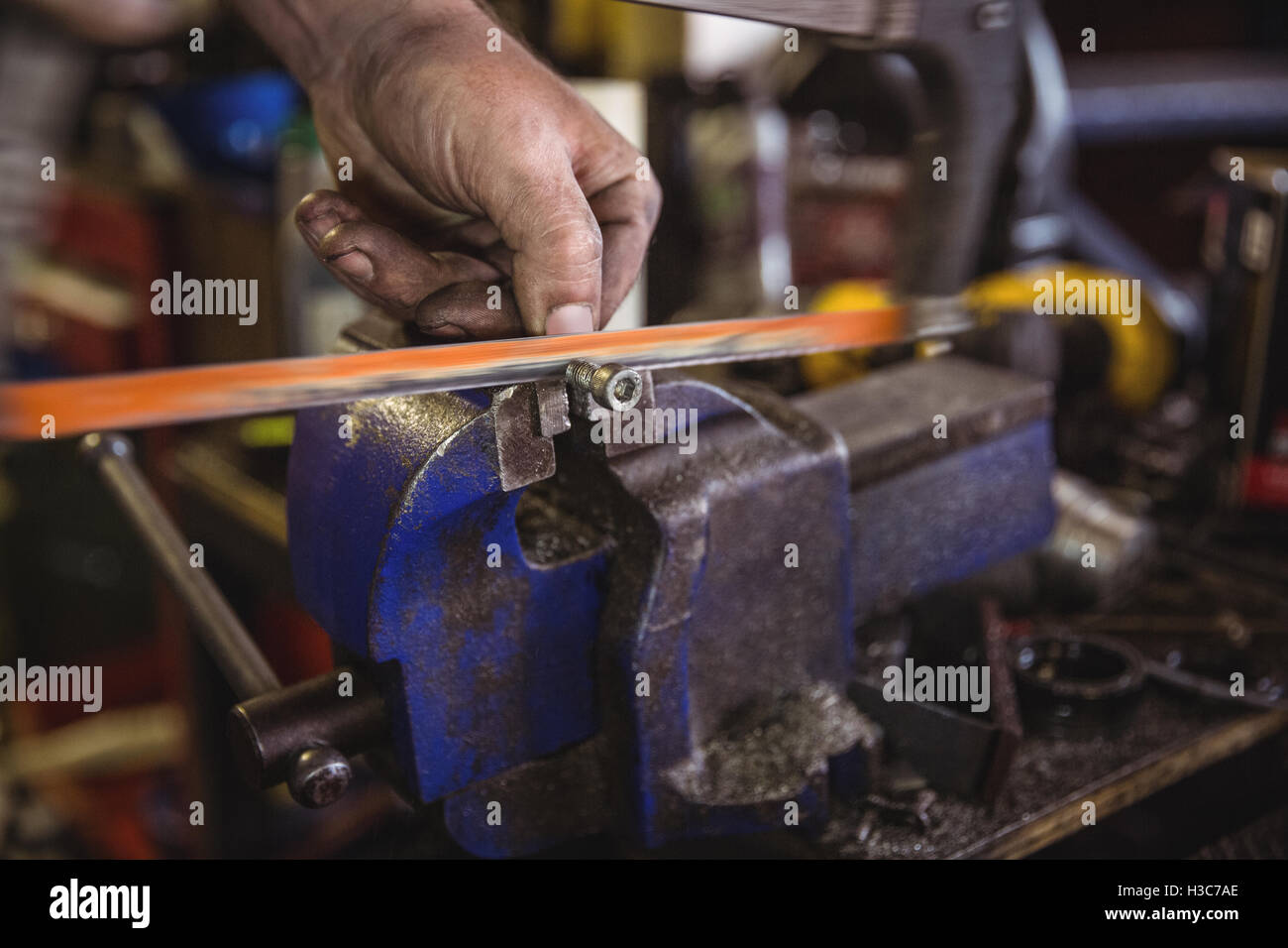 Mechanic cutting metal with tool Stock Photo - Alamy