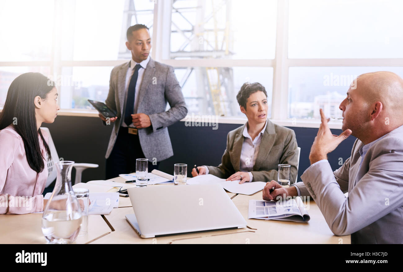 Businessman giving a presentation with electronic tablet in his hands ...