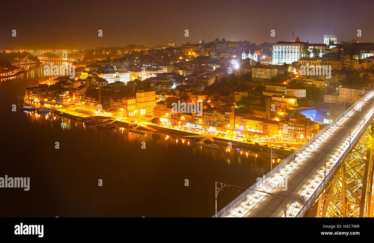 Old Town of Porto at night. Famous Dom Luis I bridge on the foreground ...