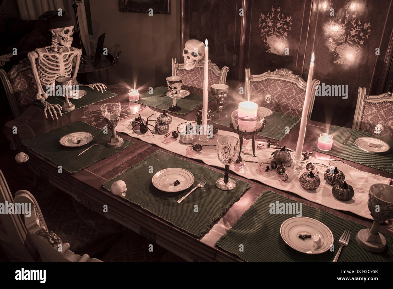 Skeleton family gathered for a Halloween dinner celebrating the holiday ...