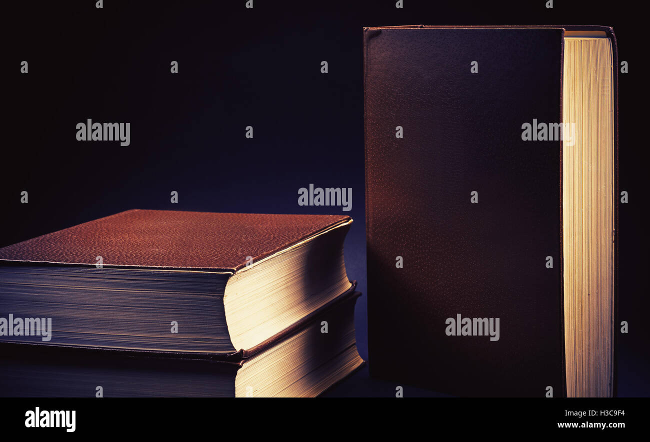 Three old book on blue background Stock Photo - Alamy