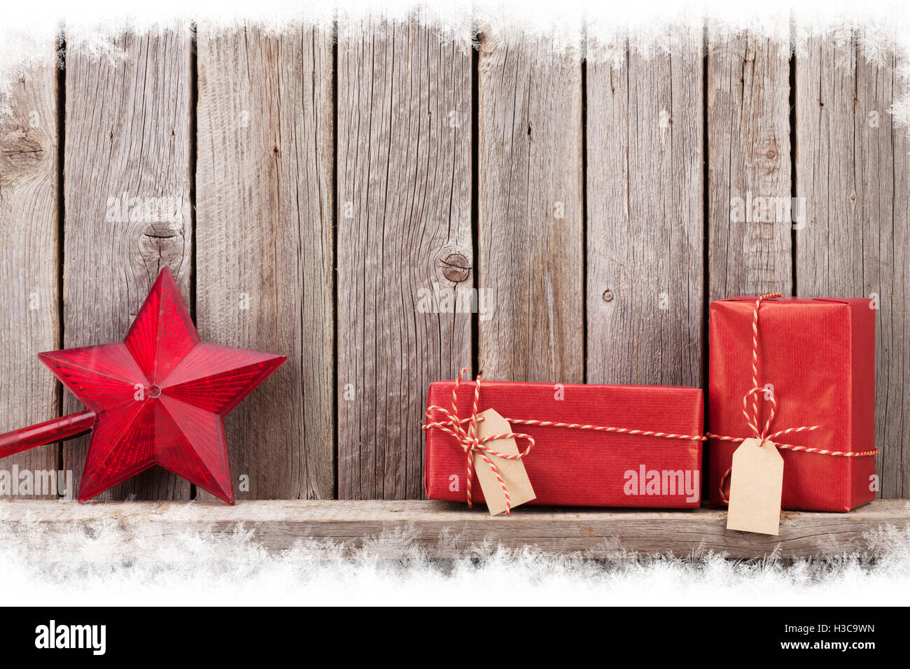 Christmas gift boxes in front of wooden wall. View with copy space for ...