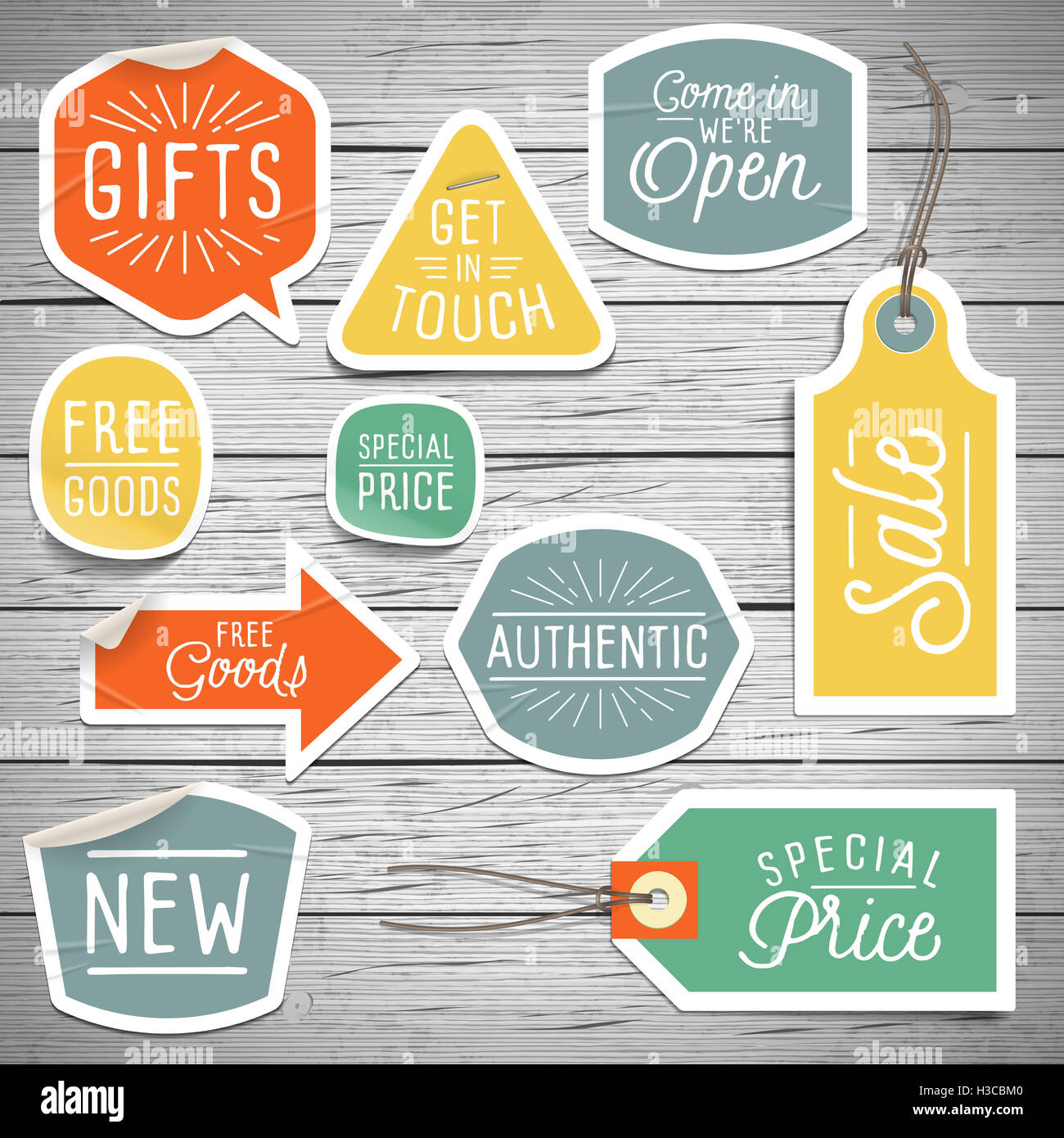 Stickers on rustic wood background for retail Stock Photo - Alamy