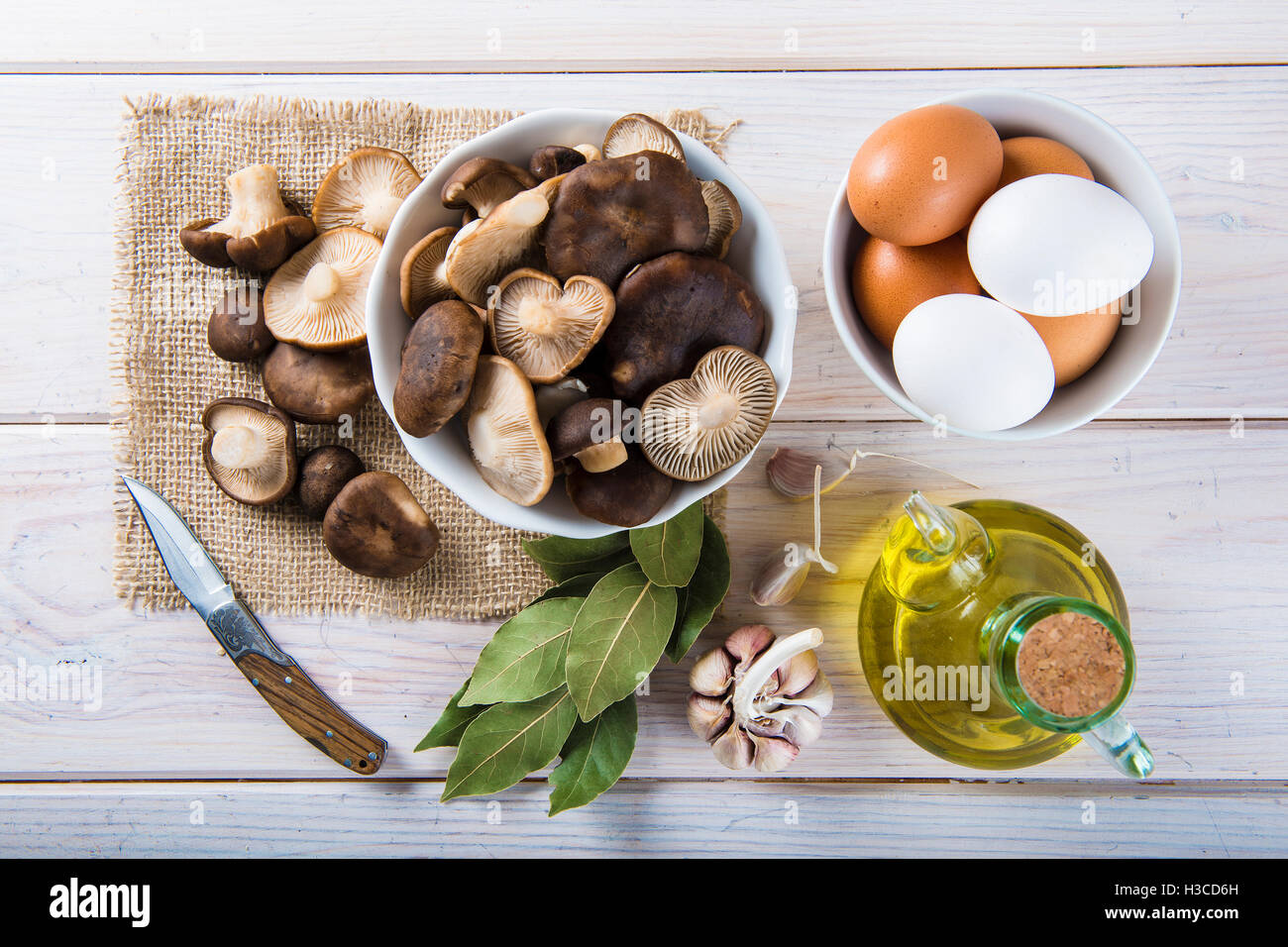 King trumpet mushrooms and ingredients for cooking on the table of the ...
