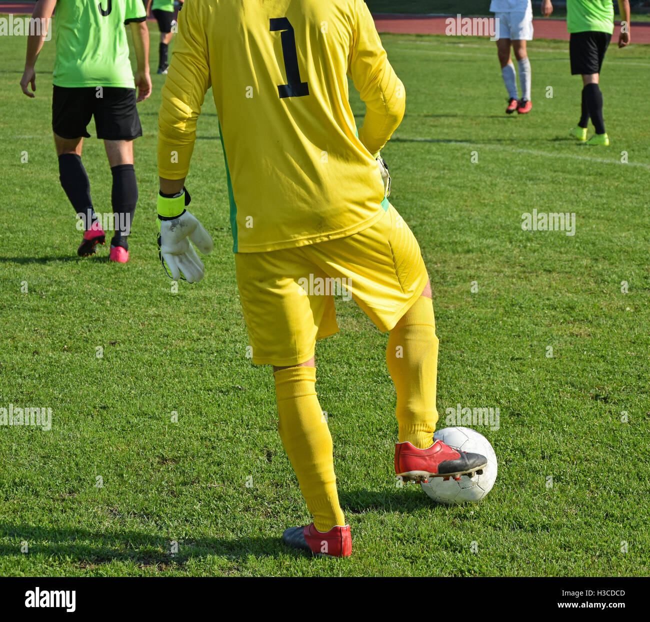 Soccer goalkeeper with a ball on a match Stock Photo - Alamy