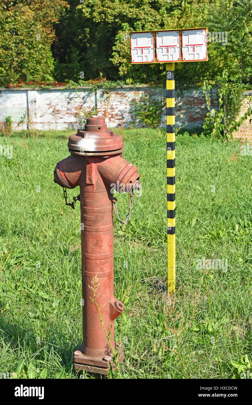 Old hydrant in the grass area in the city Stock Photo - Alamy