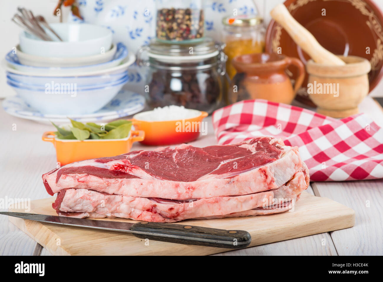Raw steaks on the kitchen table ready to cook Stock Photo - Alamy