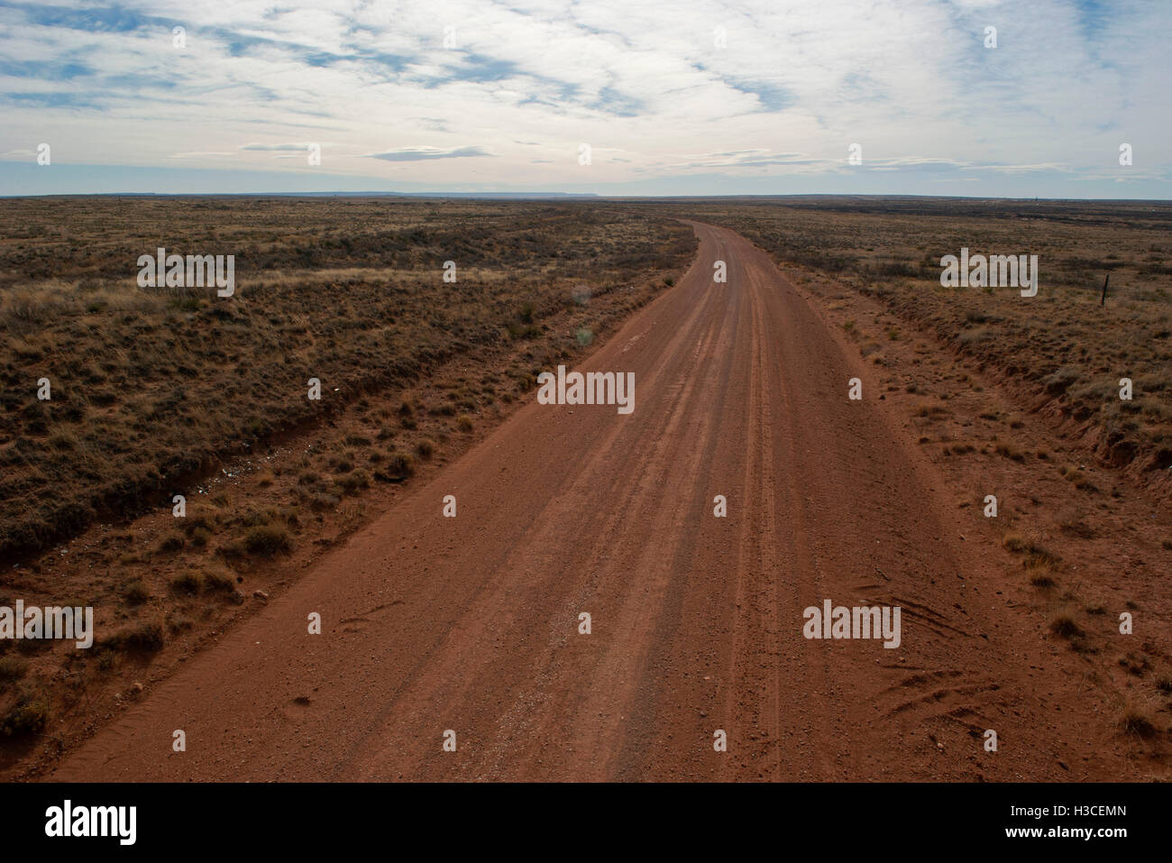 Dirt road through arid landscape Stock Photo - Alamy