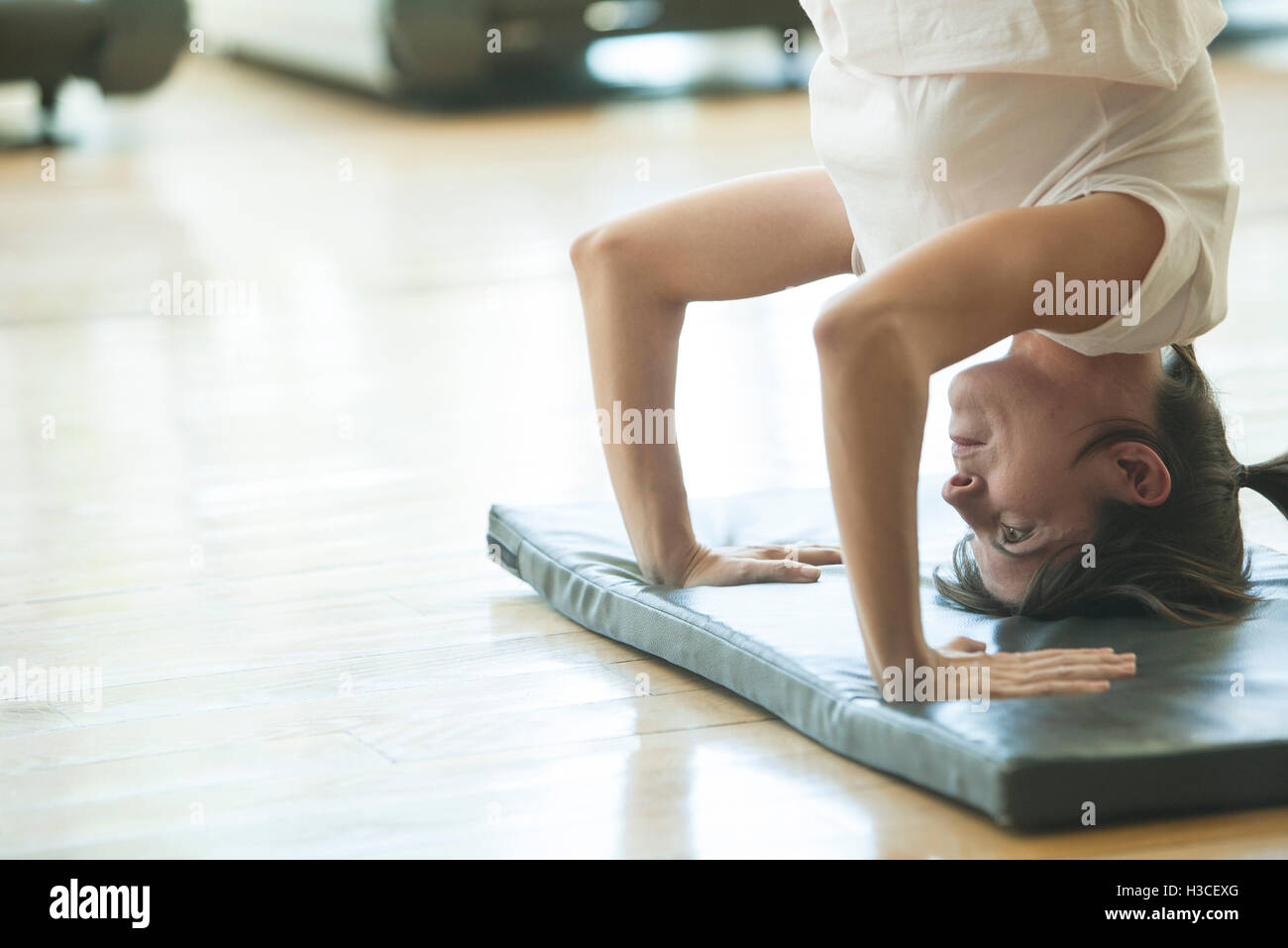 Woman doing a headstand Stock Photo - Alamy