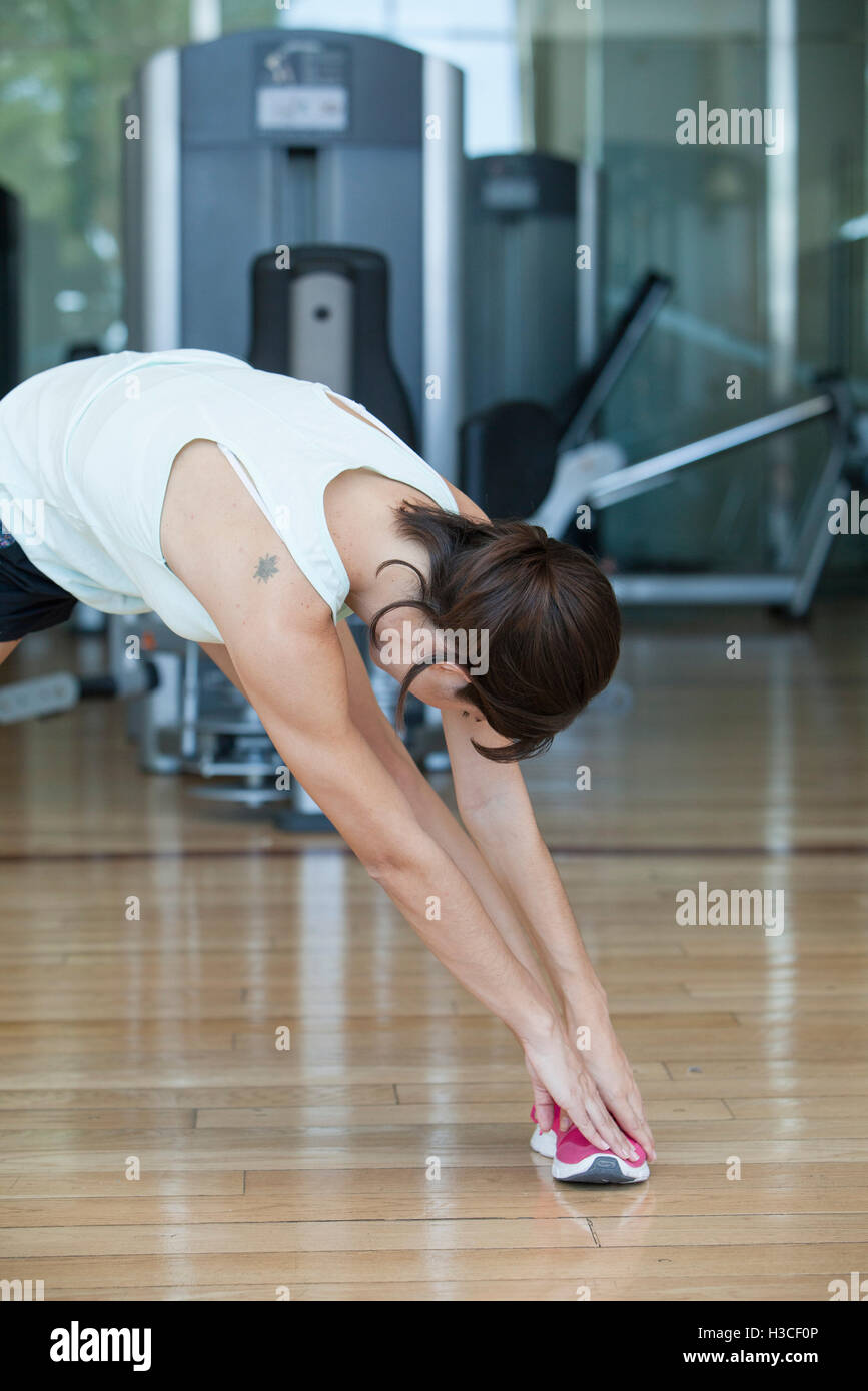 Woman bending over touching toes hi-res stock photography and images ...