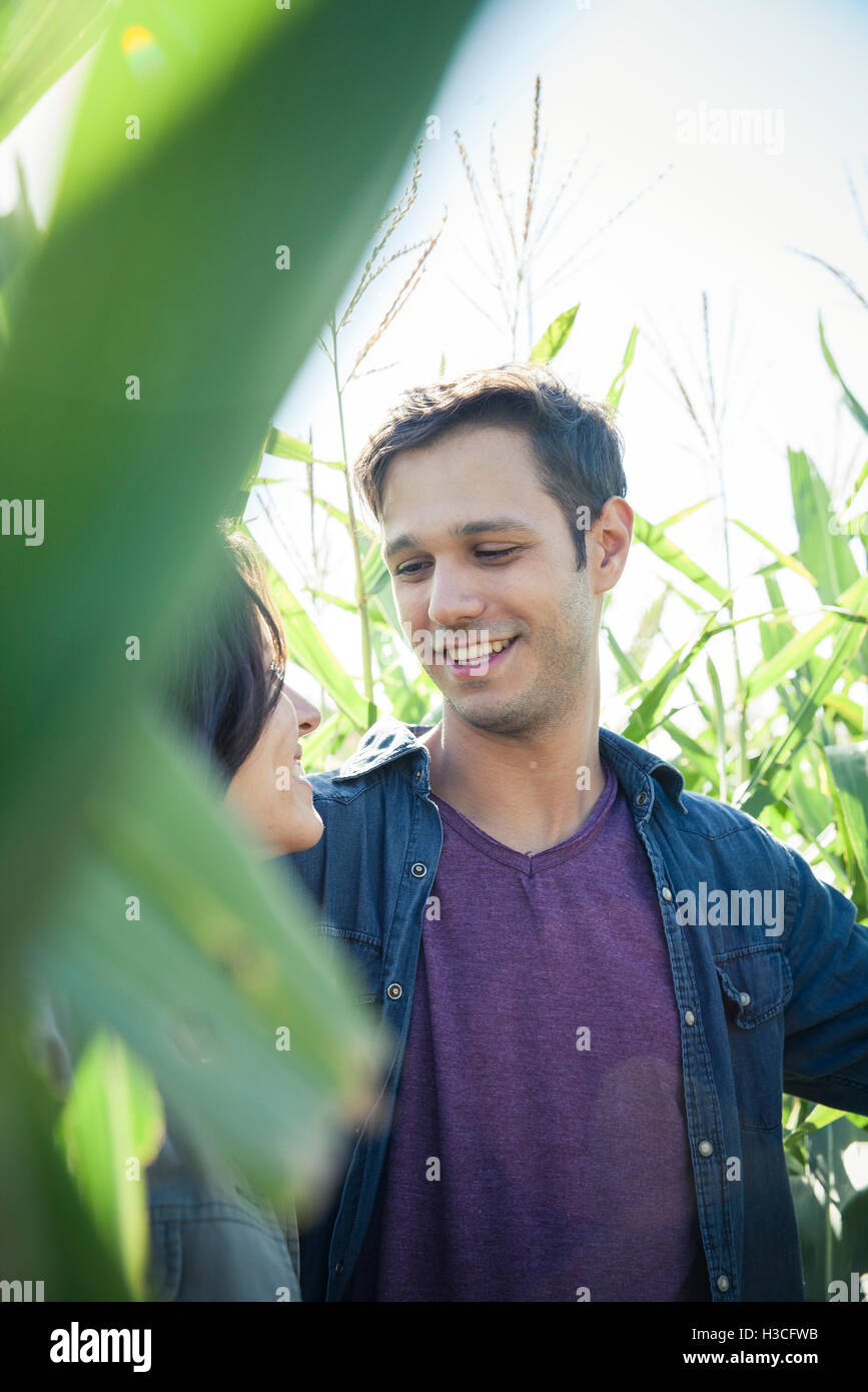 Couple talking together in cornfield Stock Photo - Alamy
